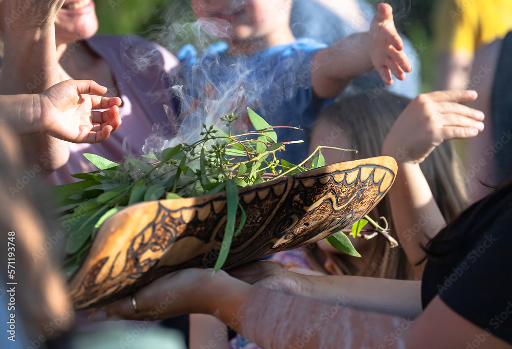 Australian Aboriginal smoking ceremony, human hands are touching the ...