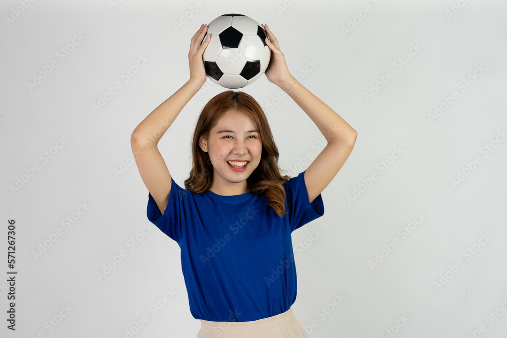 Happy Asian female soccer fan in blue shirt cheering for favorite team ...