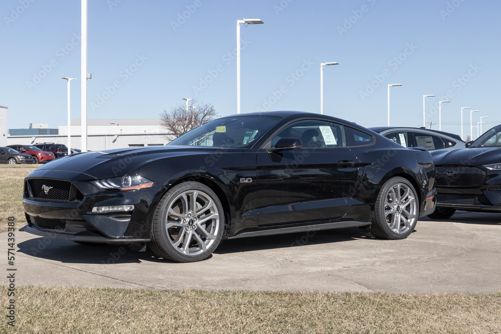 Ford Mustang display at a dealership. Ford offers the Mustang in a base ...