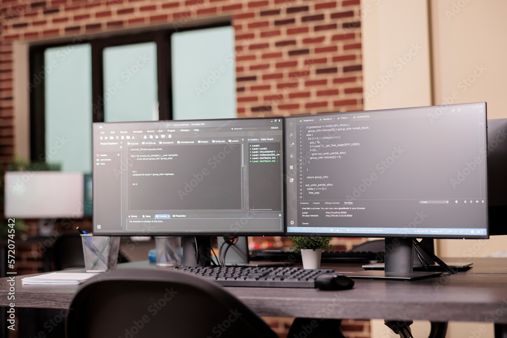 Pc desk with pc monitors running terminal window and artificial intelligence programming ...