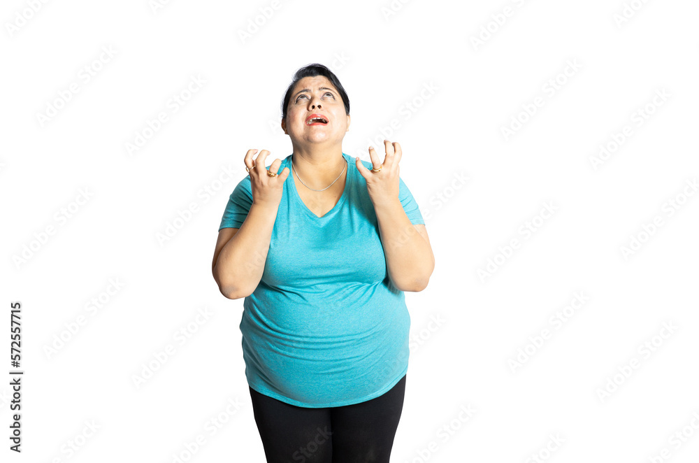 Frustrated overweight indian woman standing over white studio ...