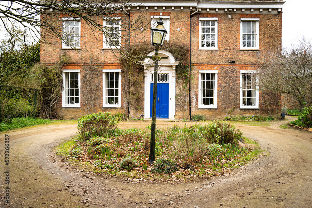 Front aspect view of an old Manor House showing a circular driveway and ...
