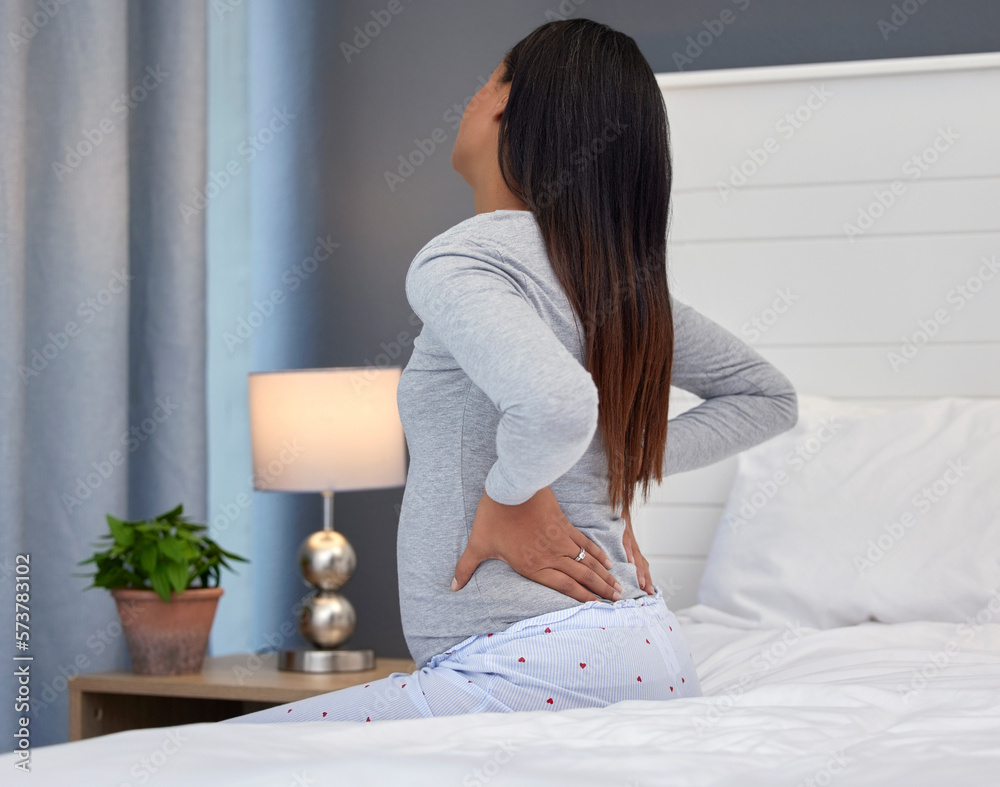 Tired, burnout and pregnant woman with back pain on a bed for rest ...