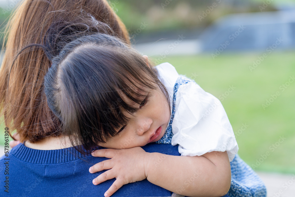 little girl receive love and hug from her mom after falling on ground ...