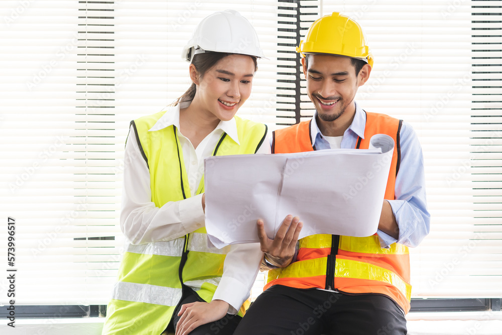 Team architect, colleague builder home, two worker asian wearing safety hard helmet, inspecting ...
