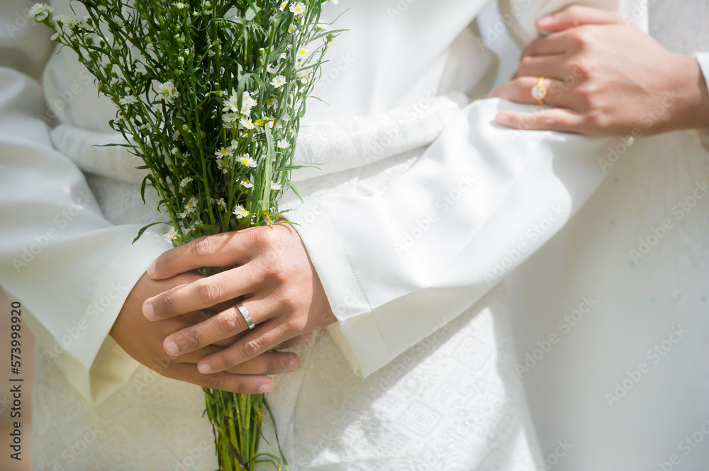 muslim groom in white suite hold hangs finger of muslim bride.concept ...