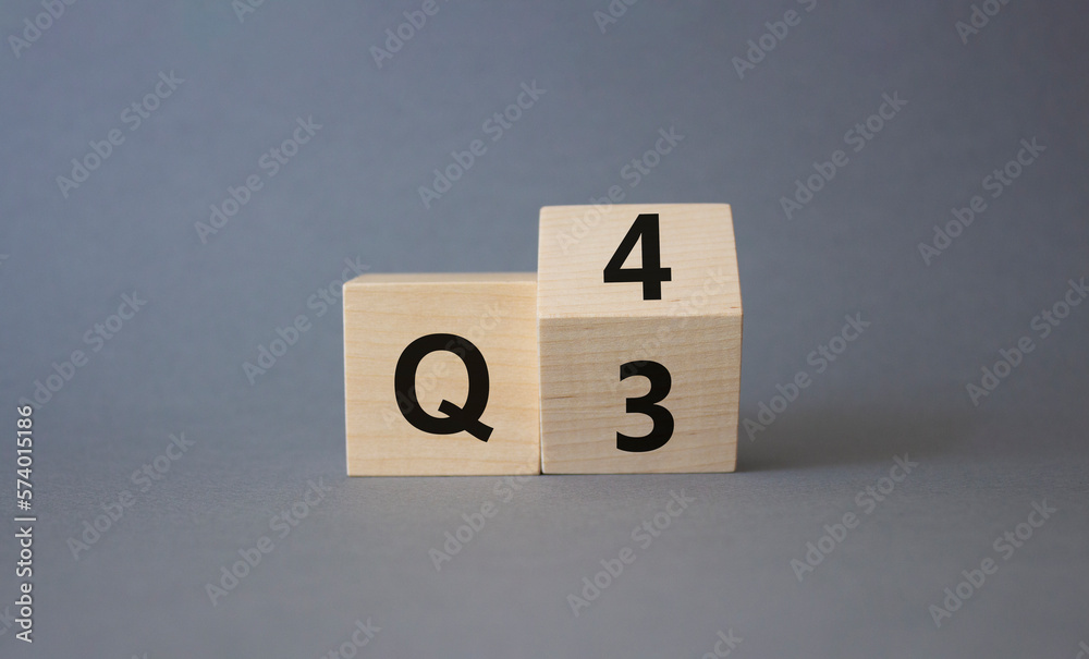 From 3rd Quarter to 4th symbol. Turned wooden cubes with words 3rd Quarter and 4th Quarter ...