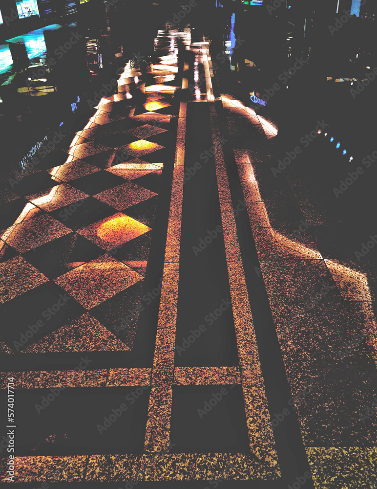 Corridor of a mall, where reflections and lights transform the ...