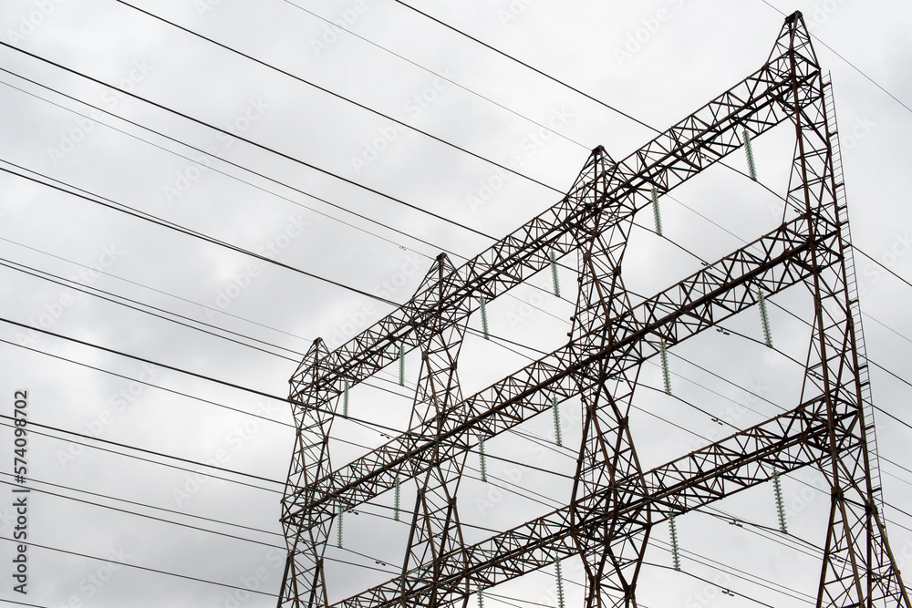 An electric utility pole with electrical wires, transmission lines ...