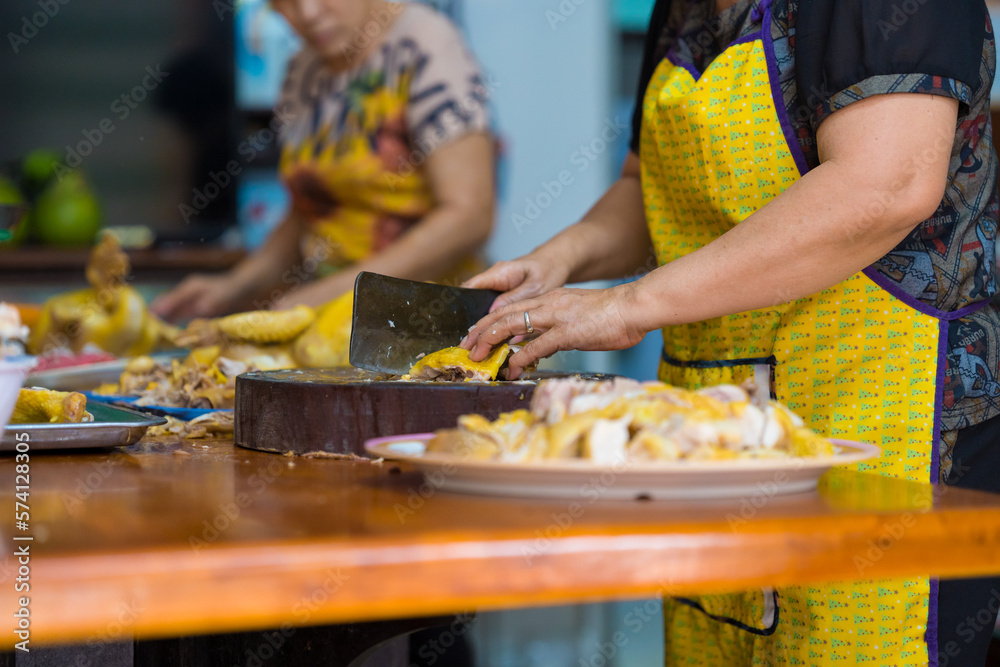Focus on Asian chefs chopping boiled chicken on wooden chopping boards ...