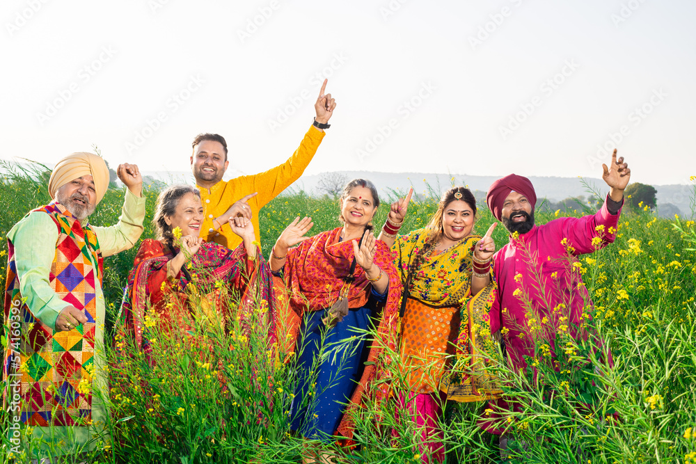 Punjabi sikh family doing bhangra dance in agriculture field ...