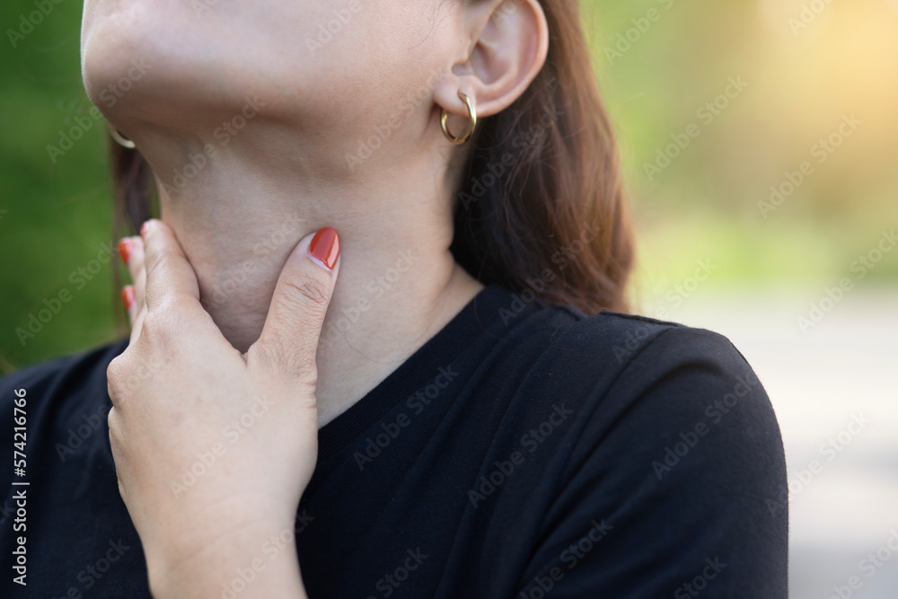 Beautiful young woman touching her sick neck with hands she has neck ...