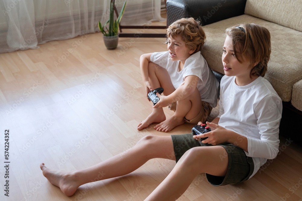 Excited children playing video games controller console two kids ...