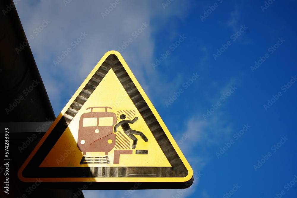 Yellow warning sign with human silhouette in black three-angle on the ...