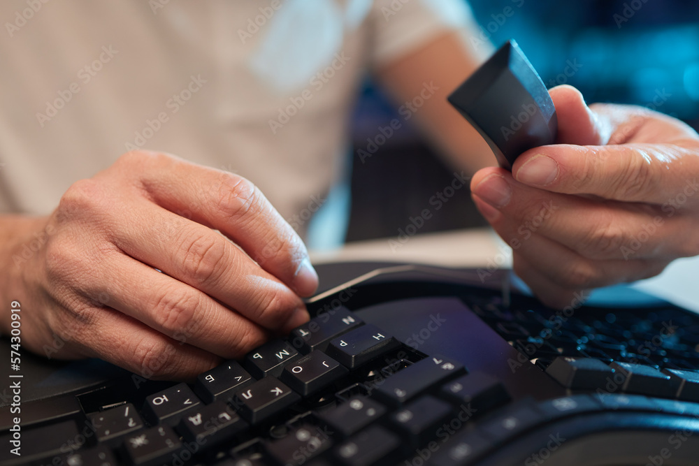 Old dirty computer keyboard with removed keys. The tools for repair and ...