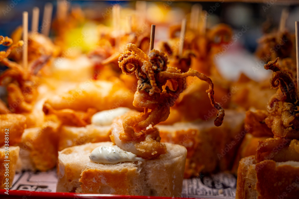 Typical snack of Basque Country, pinchos or pinxtos skewers with small ...