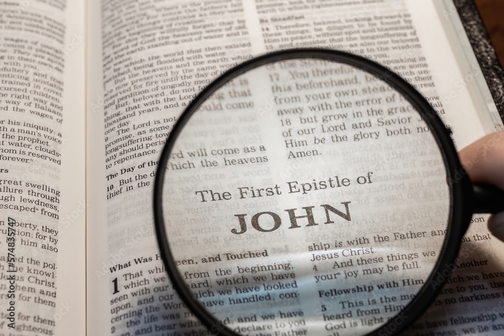 title page book of first John close up using magnifying glass in the ...