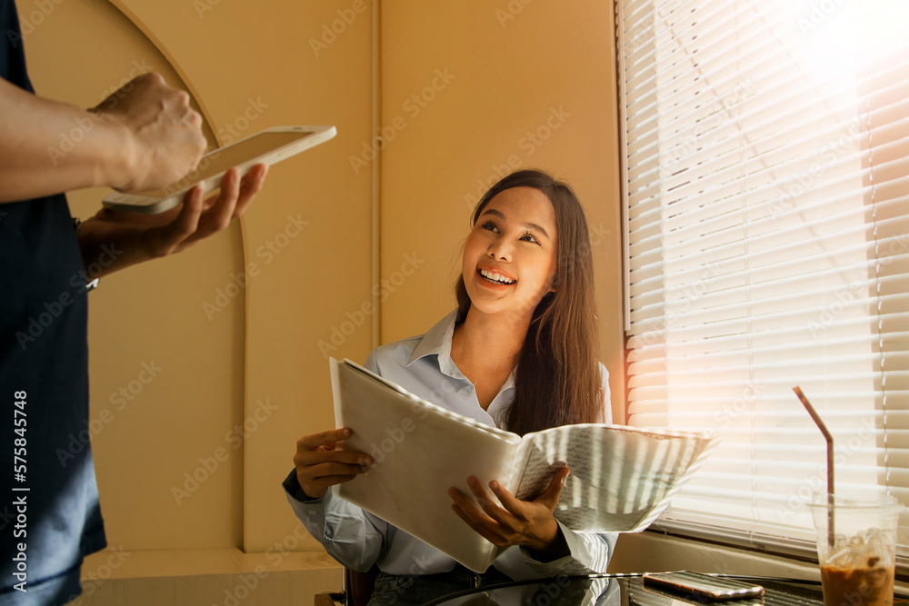 Beautiful asian female customer ordering food being served by male ...