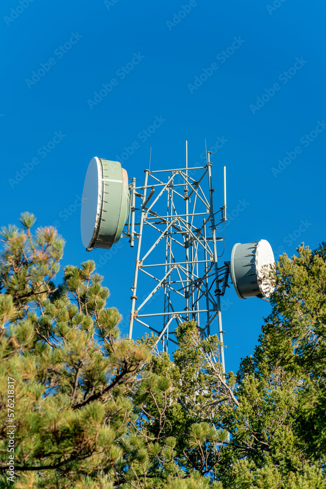 Radio tower for cell phone and internet reception and connection in afternoon sun with ...