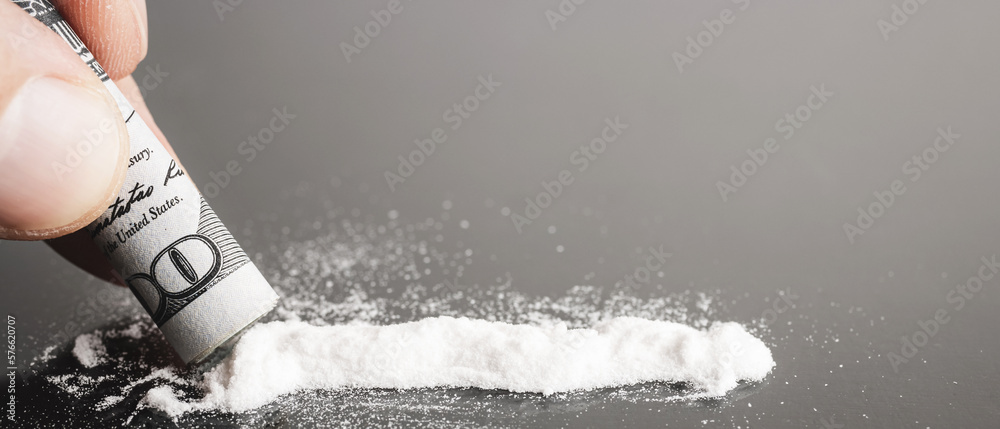 Snorting cocaine, white powder line, rolled up dollar bill, black ...