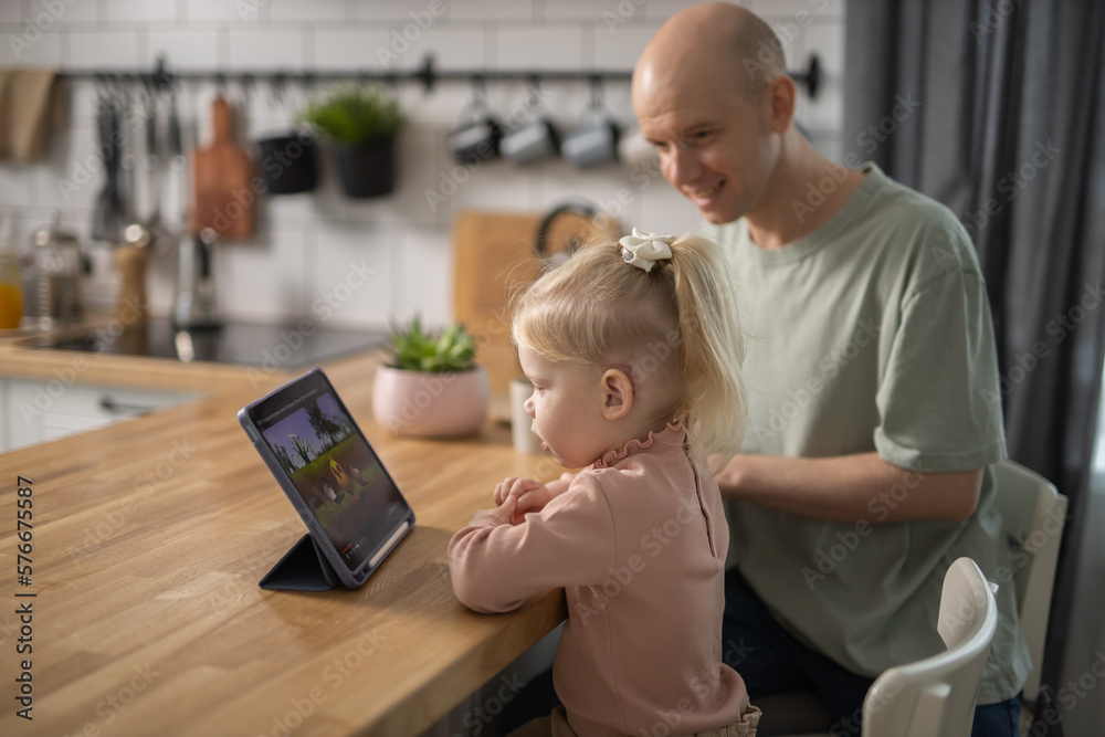 People with cochlear implant system. Kid study to hear with her father ...