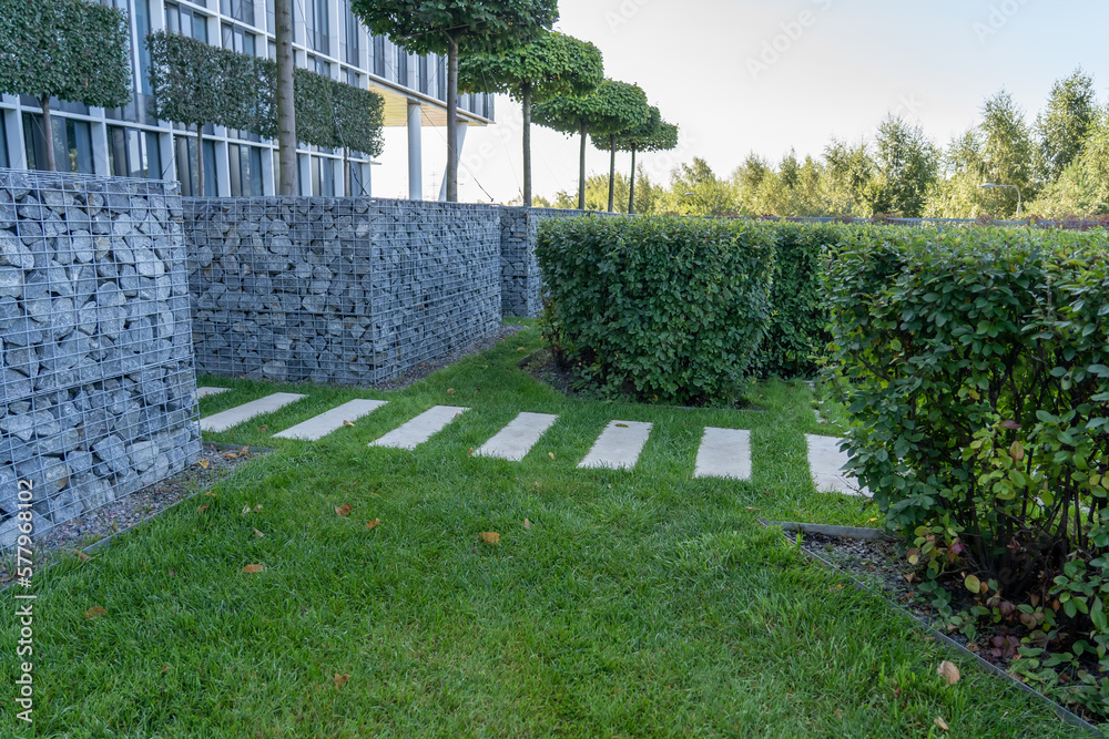 Gabion tree tubs made of wire and filled with stones, in recreation ...