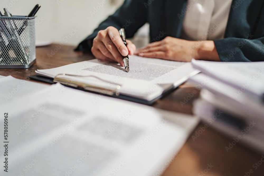 Auditor reading a report documents in office.. Stock Photo | Adobe Stock