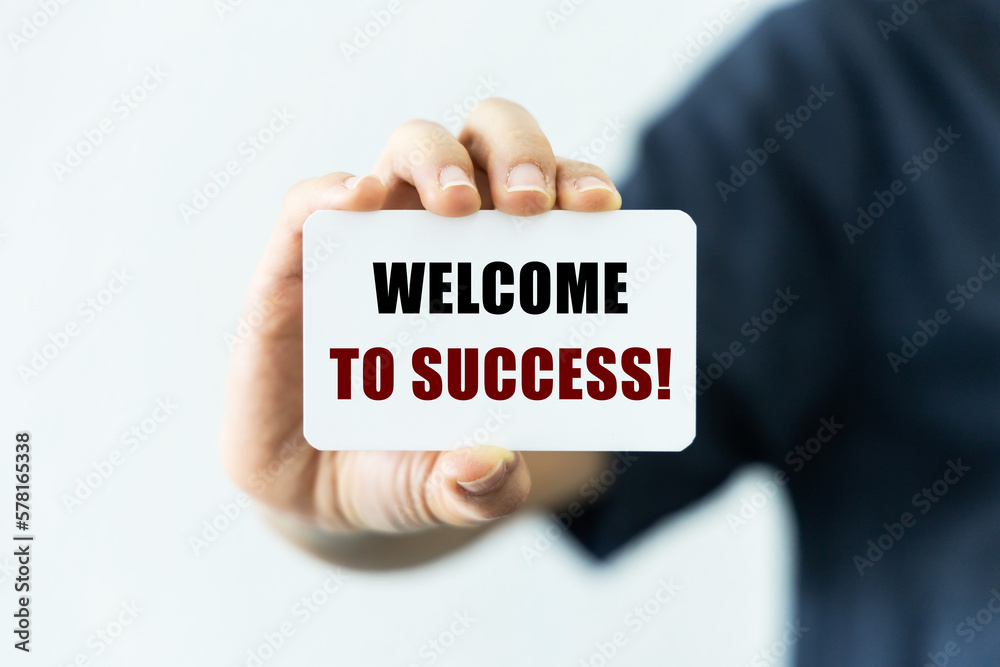 Welcome to success text on blank business card being held by a woman's ...