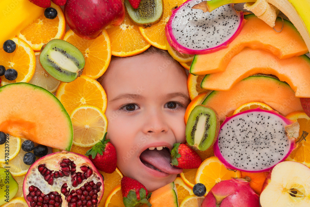 Kid licking strawberry. Healthy food background. Studio photo of ...