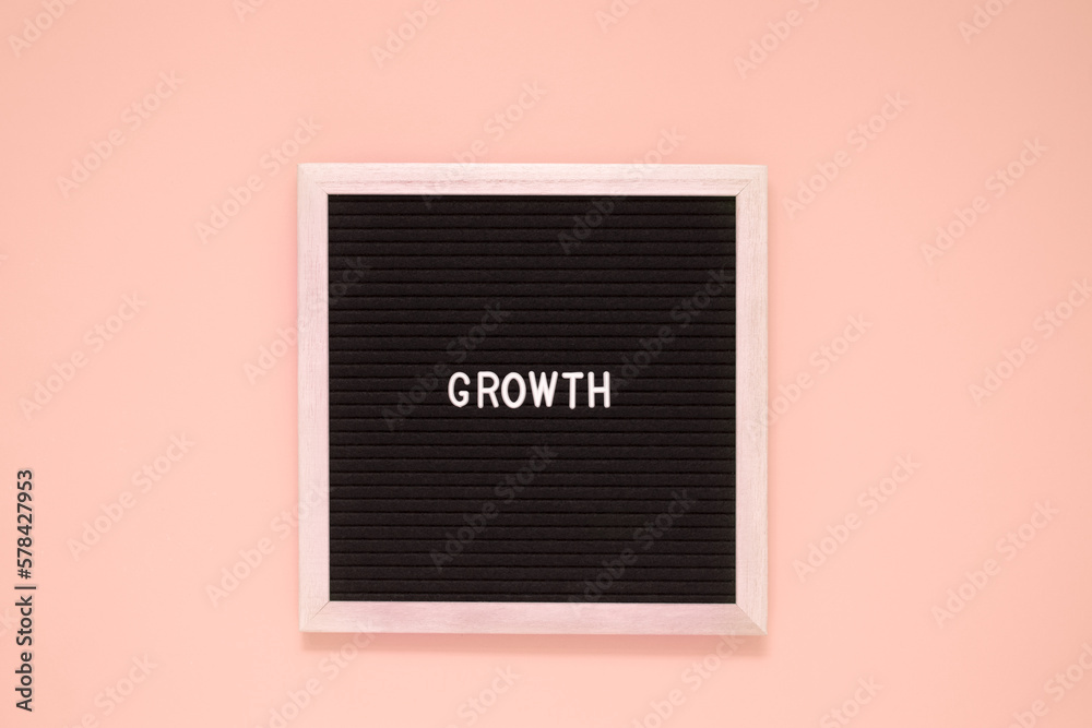 White color letter in word growth on black felt board background ...