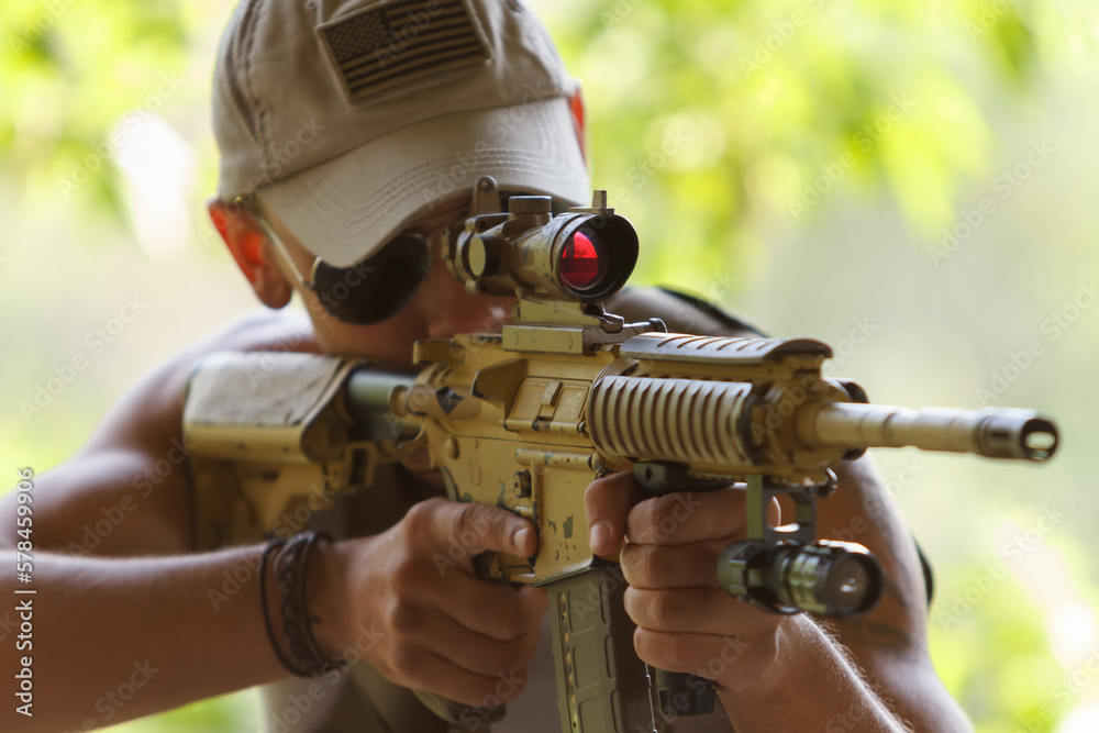 Brave young Ukrainian soldier shooting on sight with modern assault ...