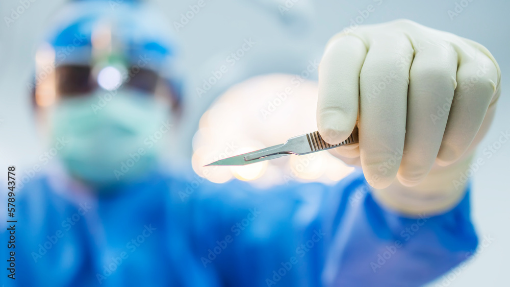Selective focus at surgeon's hand with blur background.Doctor or ...