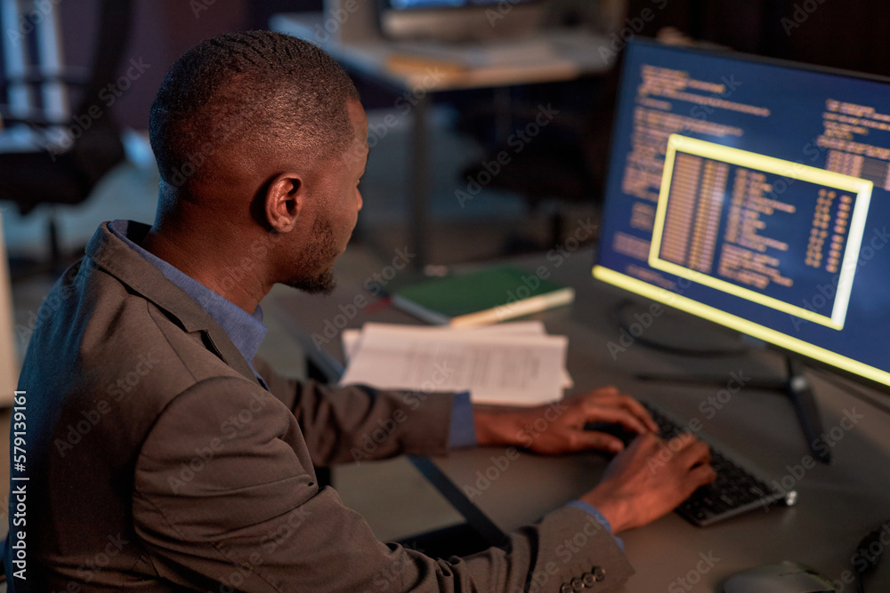 High angle view at black IT developer wearing suit and using computer ...