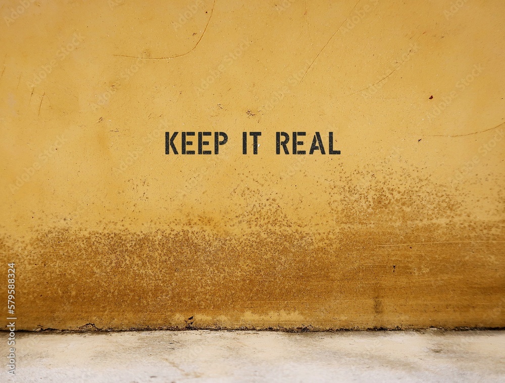 Yellow wall with text inscription KEEP IT REAL, means to be true and ...