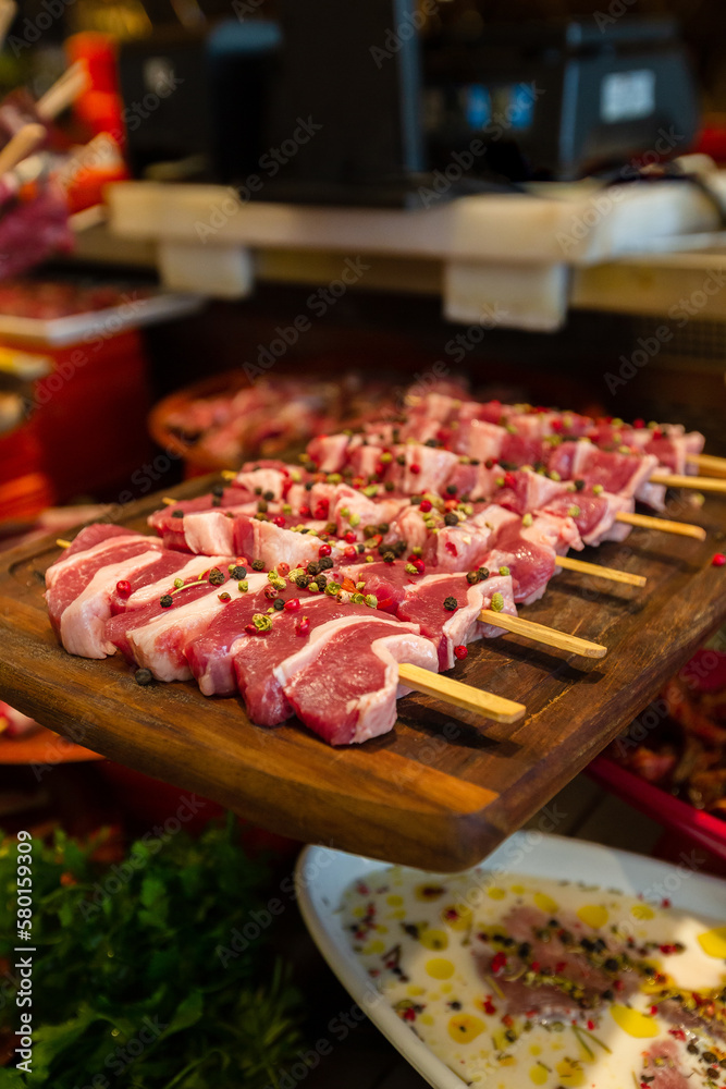 Meat department, showcase with variety of meat in different cuts ...