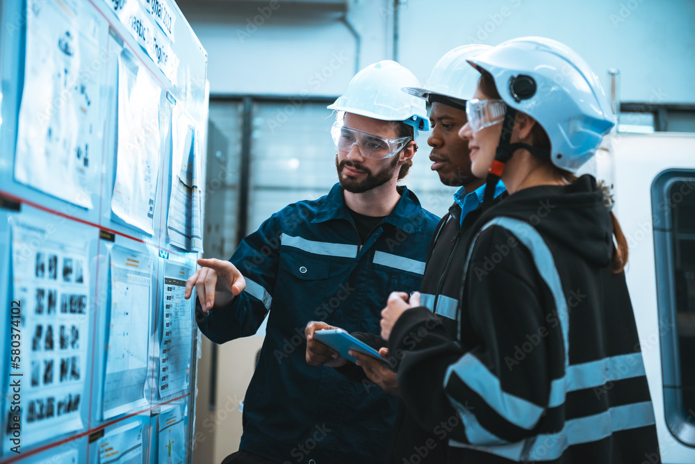 Engineer man and woman workers discussing on blueprints and working ...