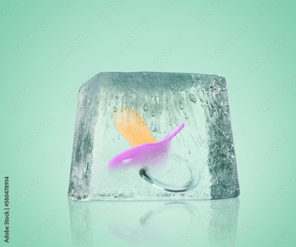 Conservation of genetic material. Baby pacifier in ice cube as ...