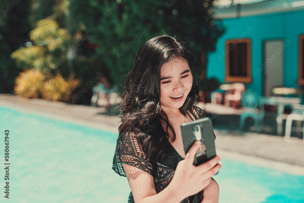 A young sweet lady taking a selfie from a lower angle on a hot summer ...