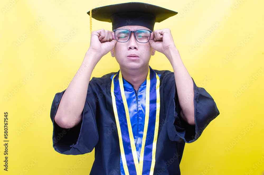 Stock-Foto „sad Asian man in graduation cap and gown rubbing his tears ...