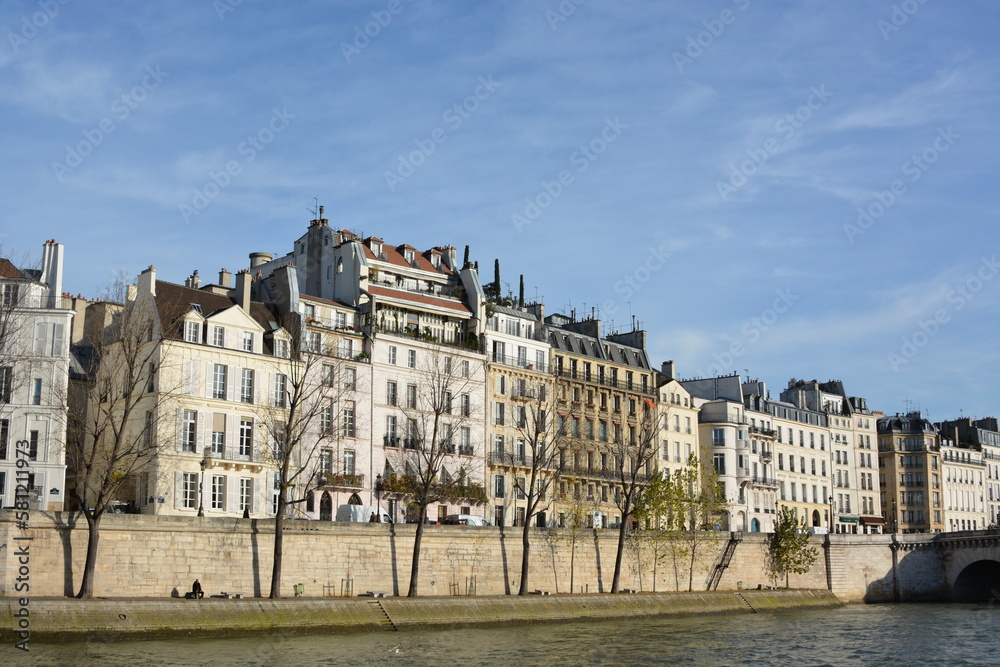 The banks of the Seine River are lined with historic buildings and ...