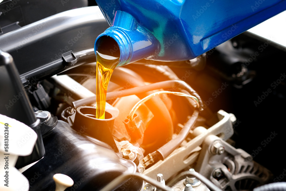 Refueling and pouring oil quality into the engine motor car ...