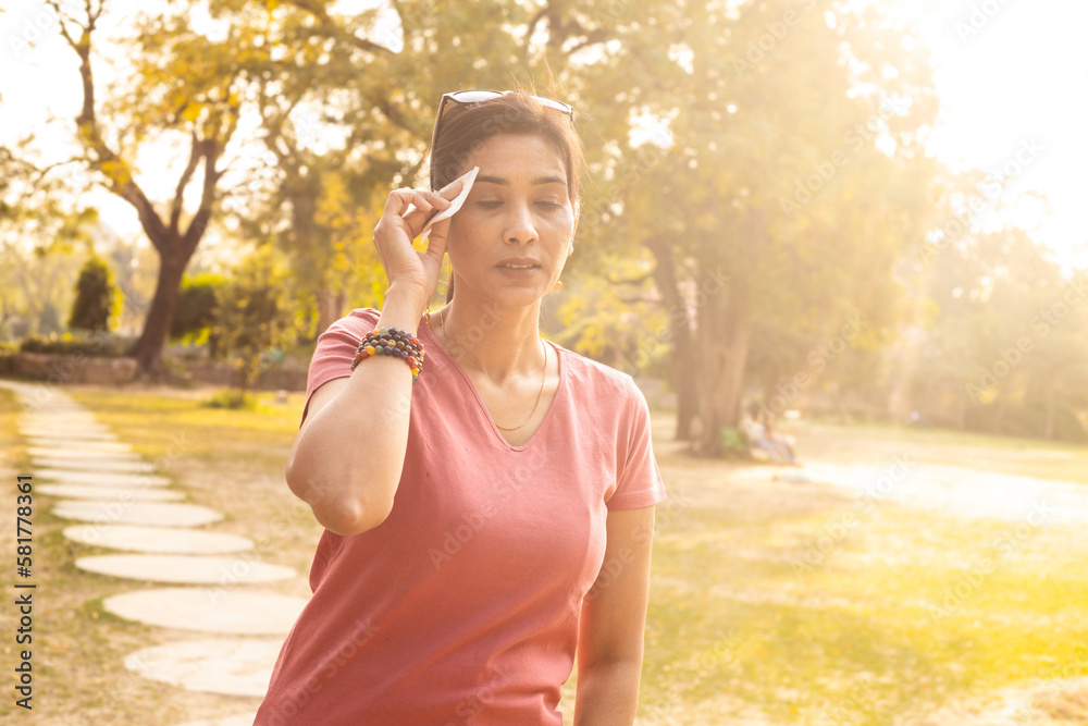Exhausted Indian woman sweating in hot summer sunlight - heat stroke ...