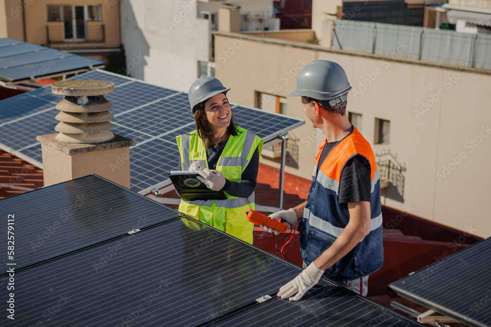 Female engineer testing urban Solar Panels with Multimeter and ...