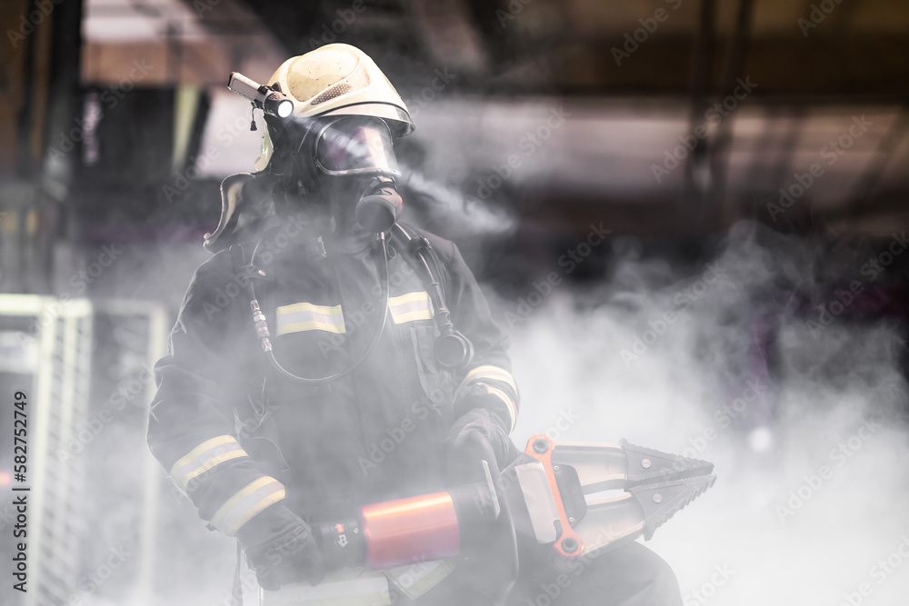 Fireman portrait wearing full equipment and oxygen mask. Firefighter ...