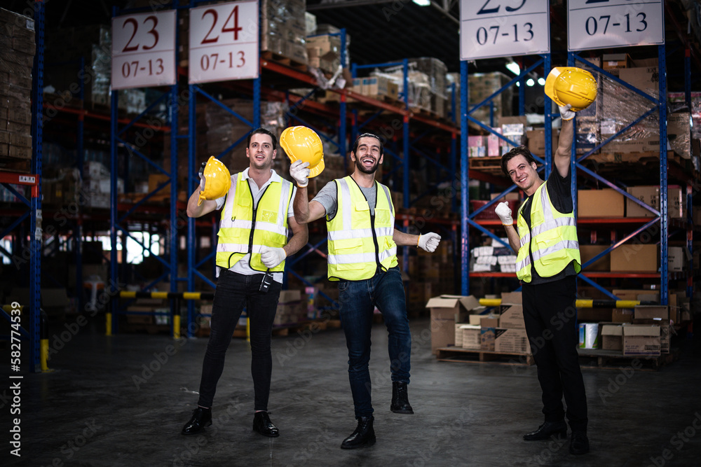 Caucasian male warehouse workers showing teamwork and partnership ...
