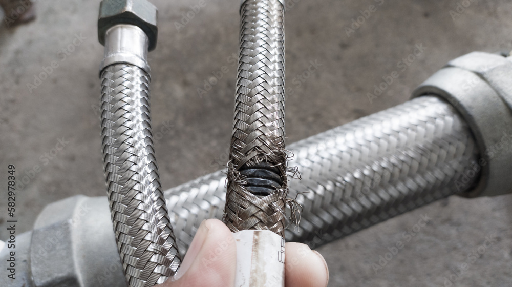 Example of flexible hose damage due to friction. Stock Photo | Adobe Stock