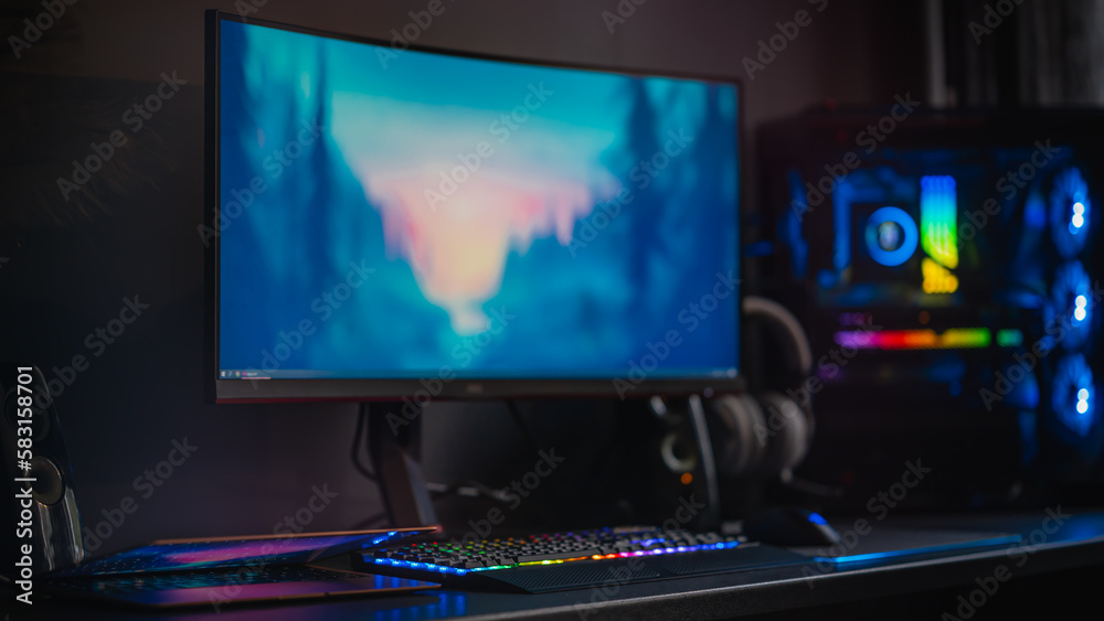 Modern Gaming PC desktop gaming setup, RGB lights, widescreen monitor and water cooling. Blue ...