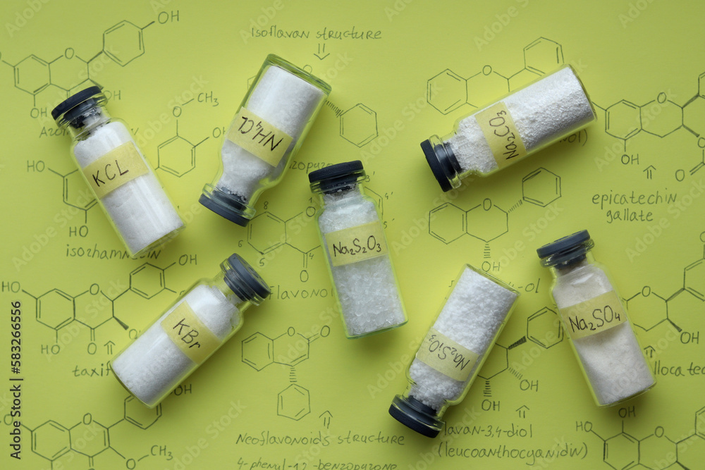 White powder reagents in glass bottles: ammonium chloride, potassium ...