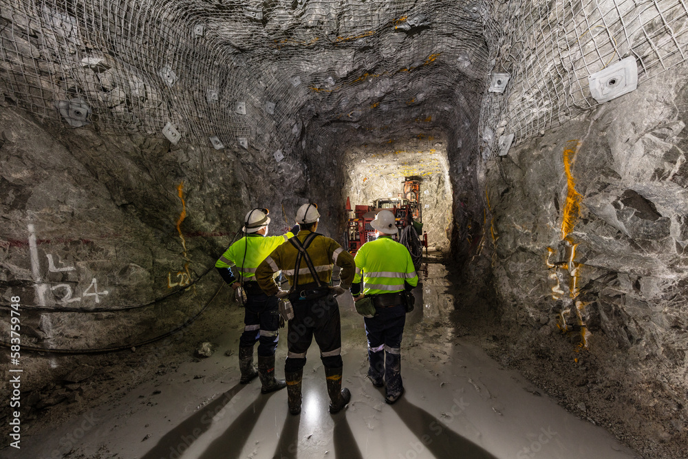 Miners underground inspecting work in progress at a mine site in ...