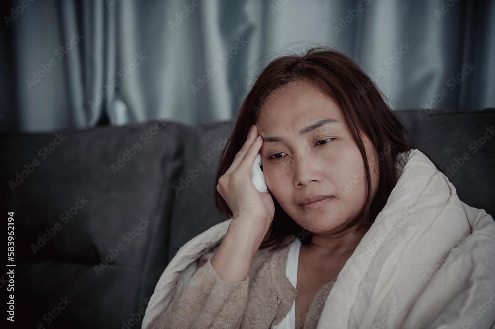 Asian sick woman sit on the sofa stay at home,The woman felt bad ...